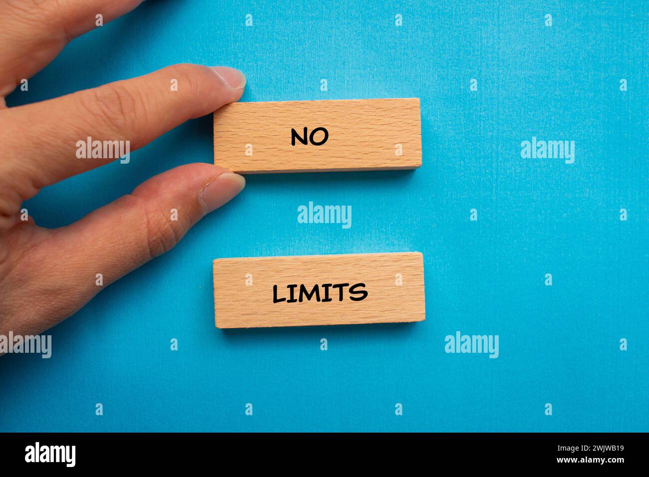 No limits words written on wooden blocks with blue background ...