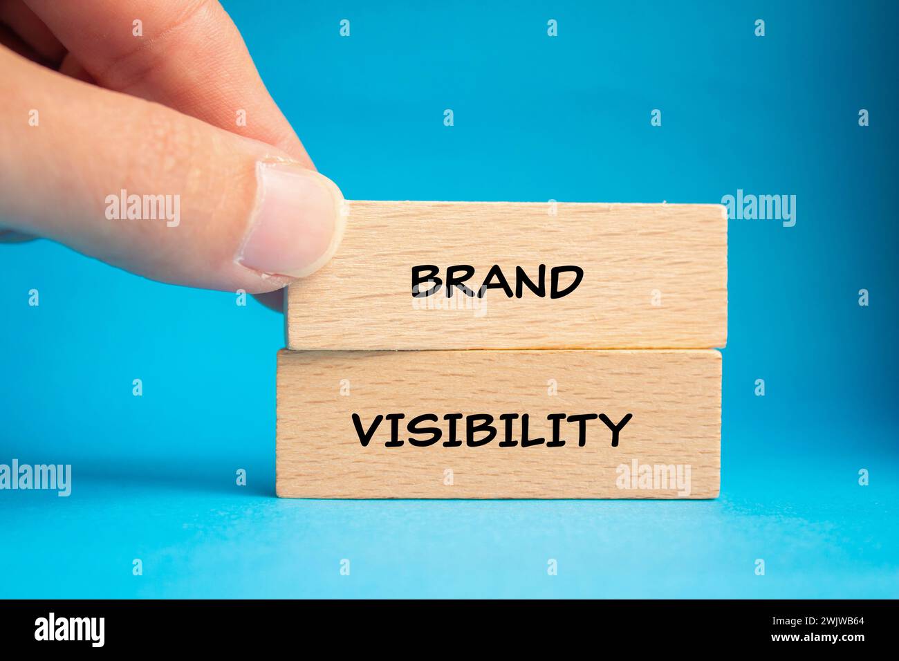 Brand visibility words written on wooden blocks with blue background ...