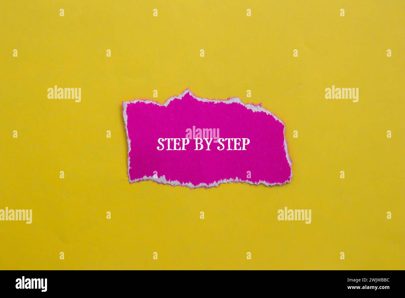 Step by step words written on torn pink paper with yellow background ...