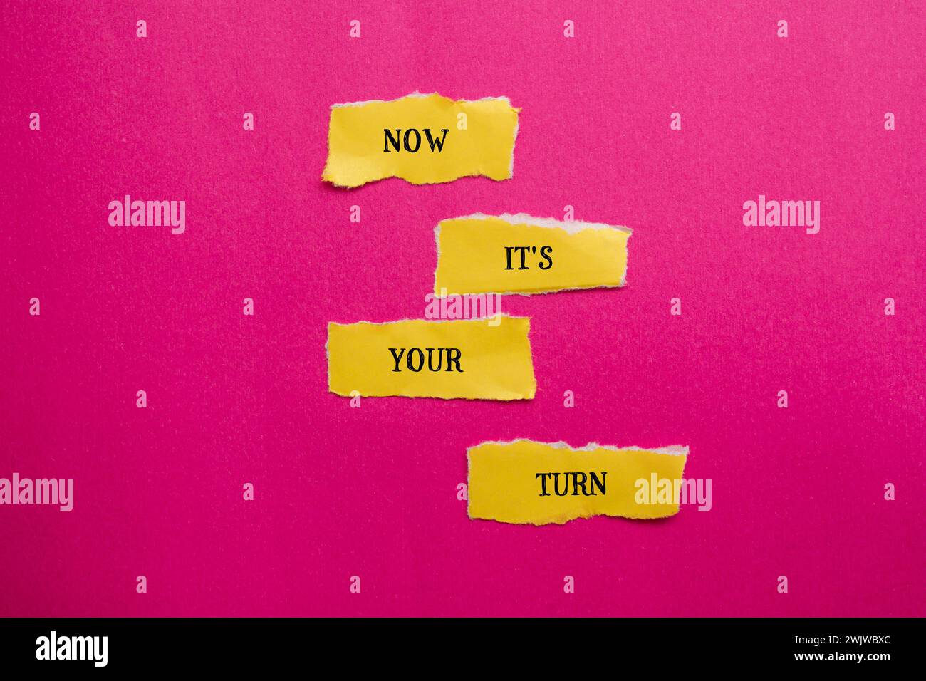 Now it's your turn words written on yellow torn paper pieces with pink ...
