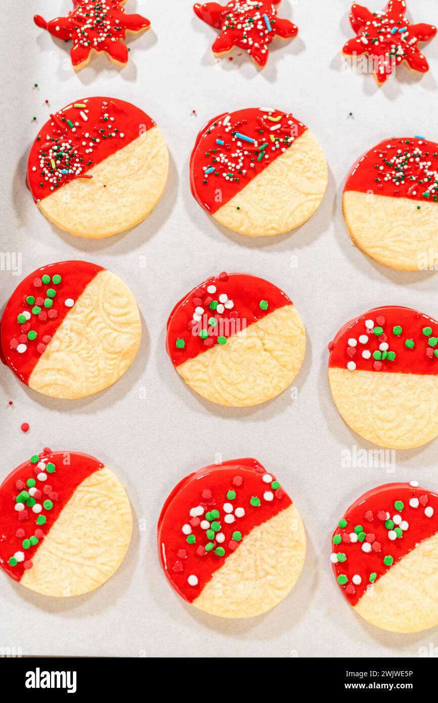 Decorating with Red Melted Chocolate and Vibrant Green Sprinkles Stock ...