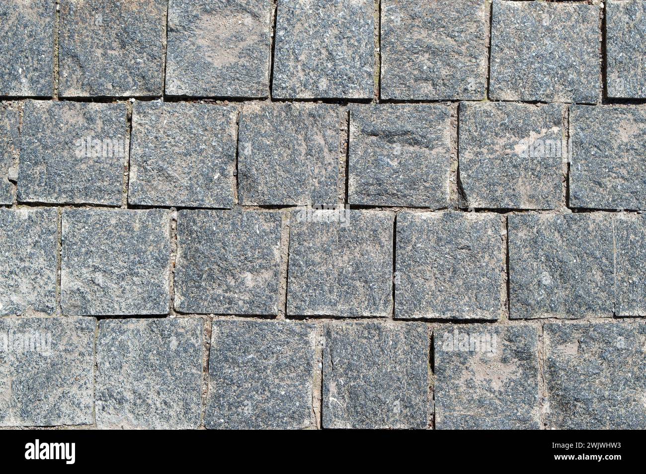 Cobbled granite pavement background, regular shapes of cobbled stone ...
