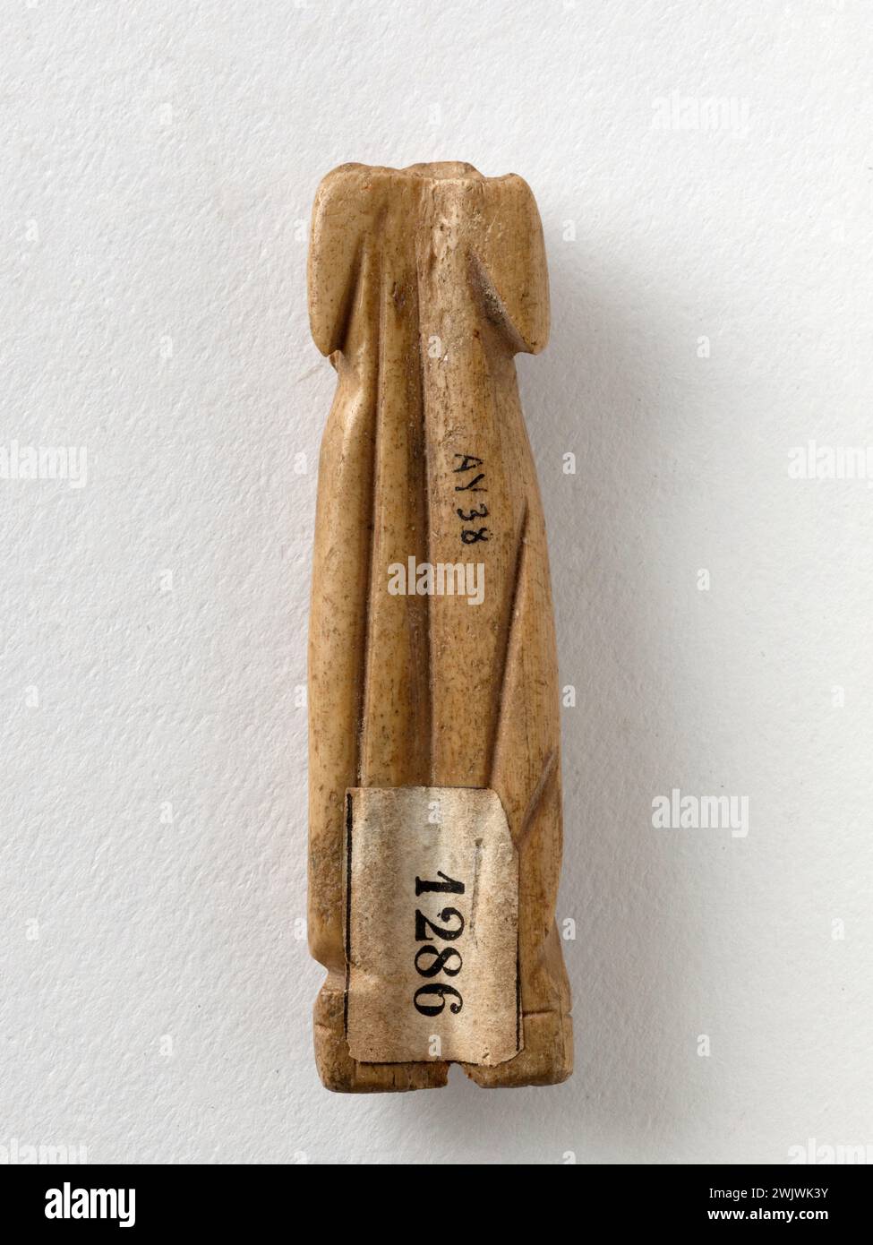 Handle in the shape of a acephalous female statuette. Sculpted bone ...