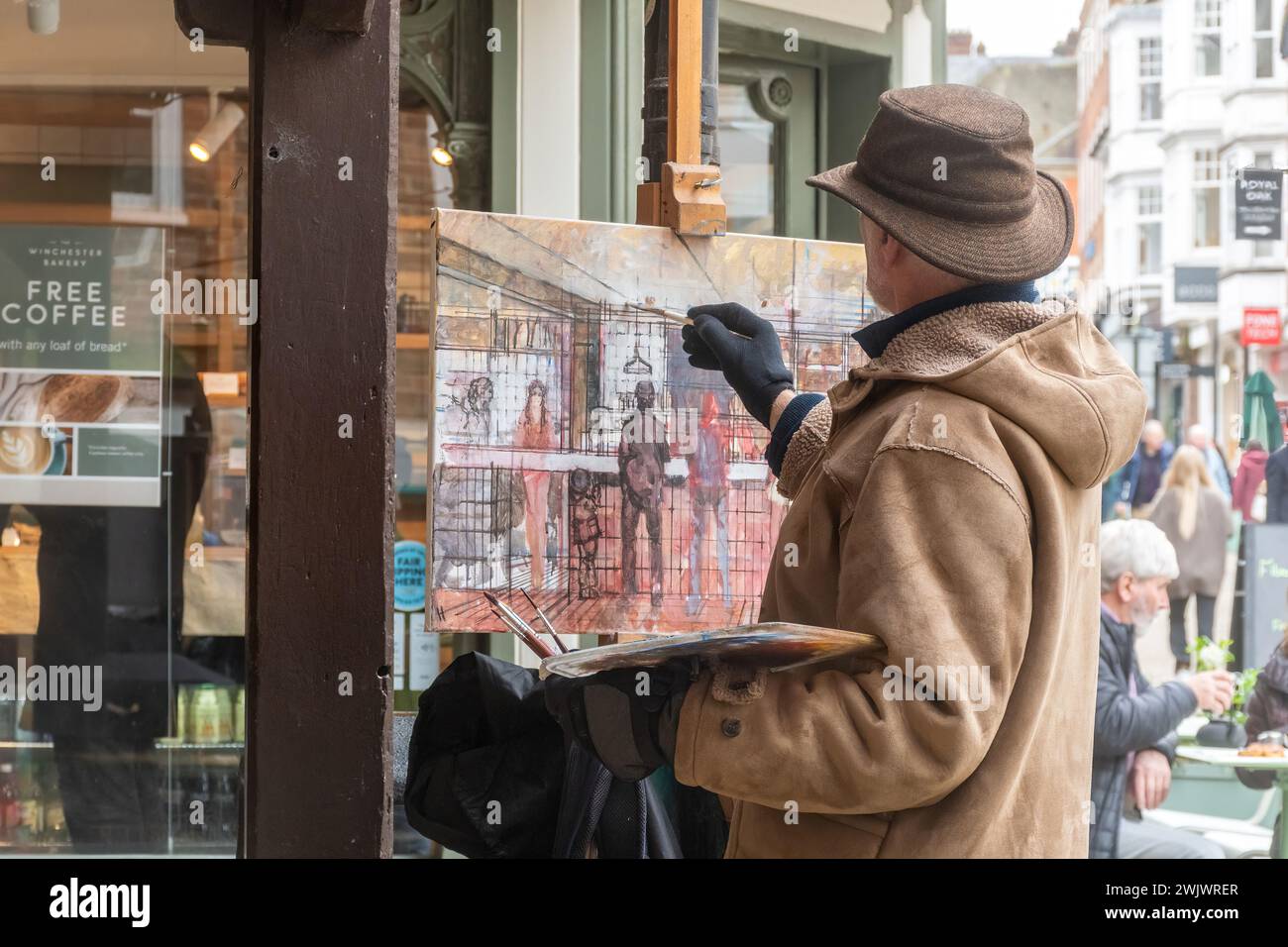 An artist paints a painting of people in a coffee shop on Winchester ...