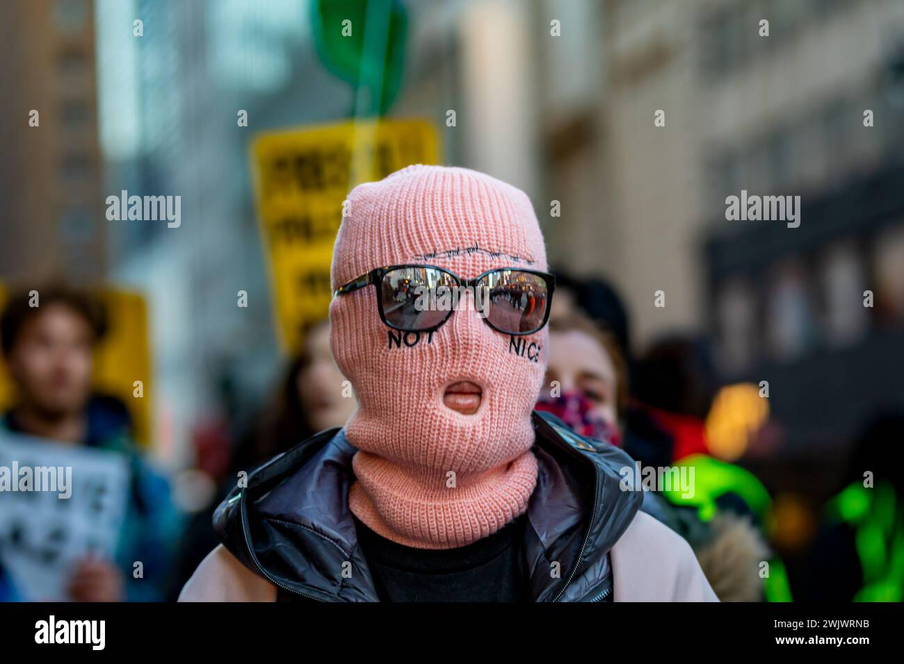 A pro-Palestine protester wears a face covering with the words "Not ...