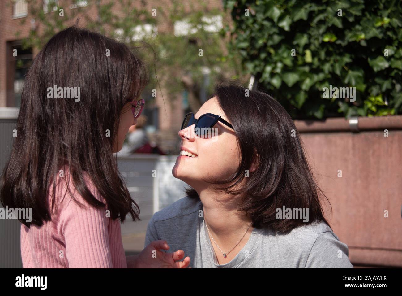 Child talking to adult, street hi-res stock photography and images - Alamy