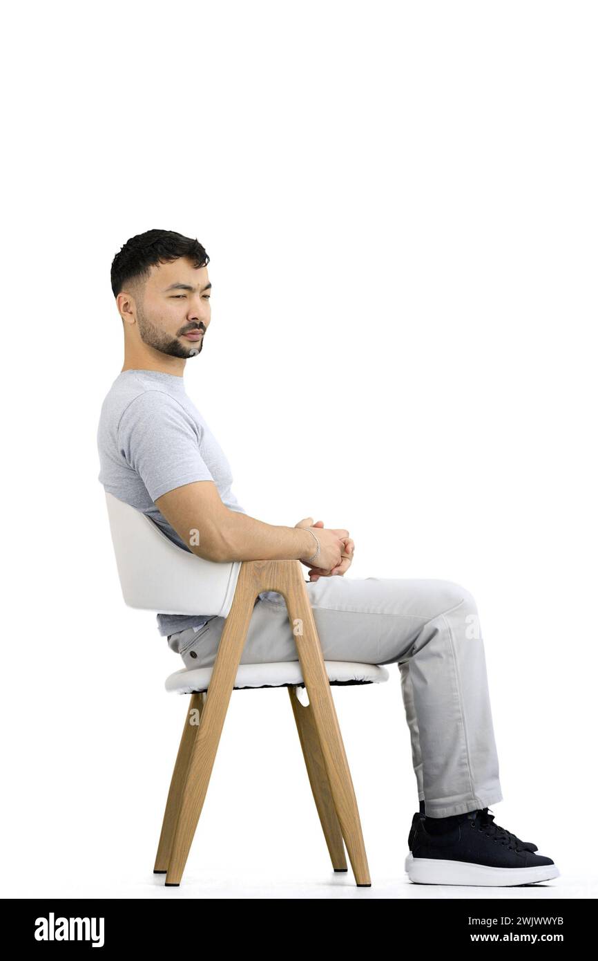 A man, on a white background, in full height, sitting on a chair Stock ...