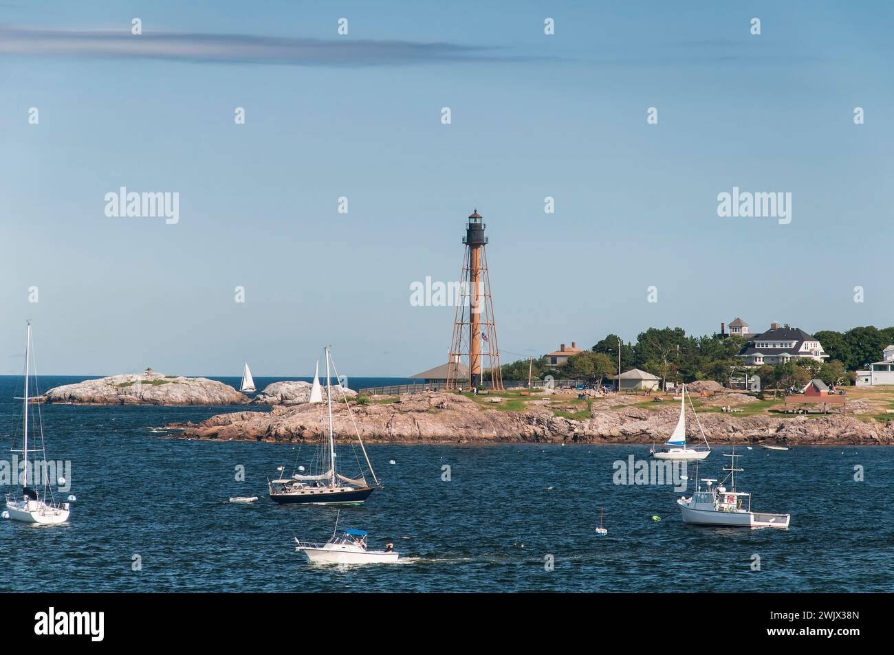 Boats moored offshore near Marblehead Lighthouse in marblehead ...