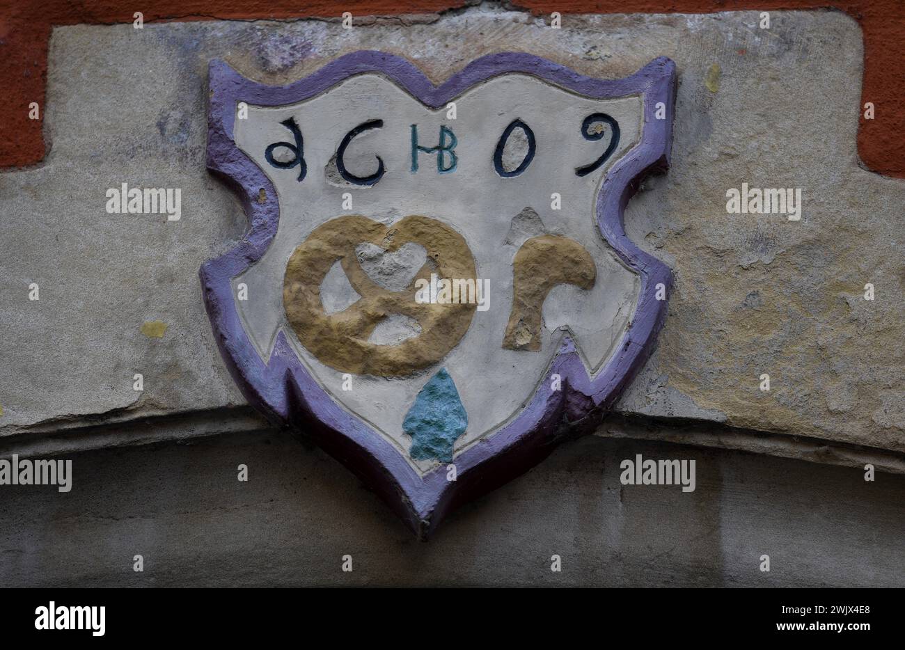 Antique sign on an arched stone trimmed portal in Turckheim, Alsace ...
