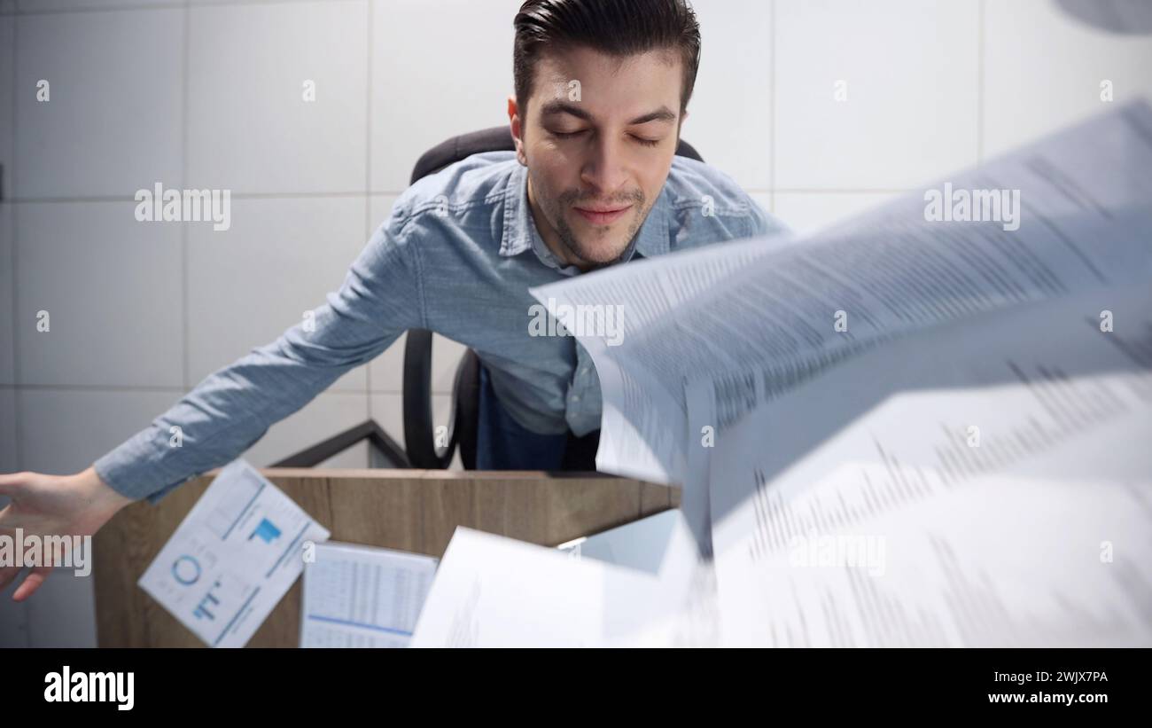 Man laptop holding papers hi-res stock photography and images - Alamy