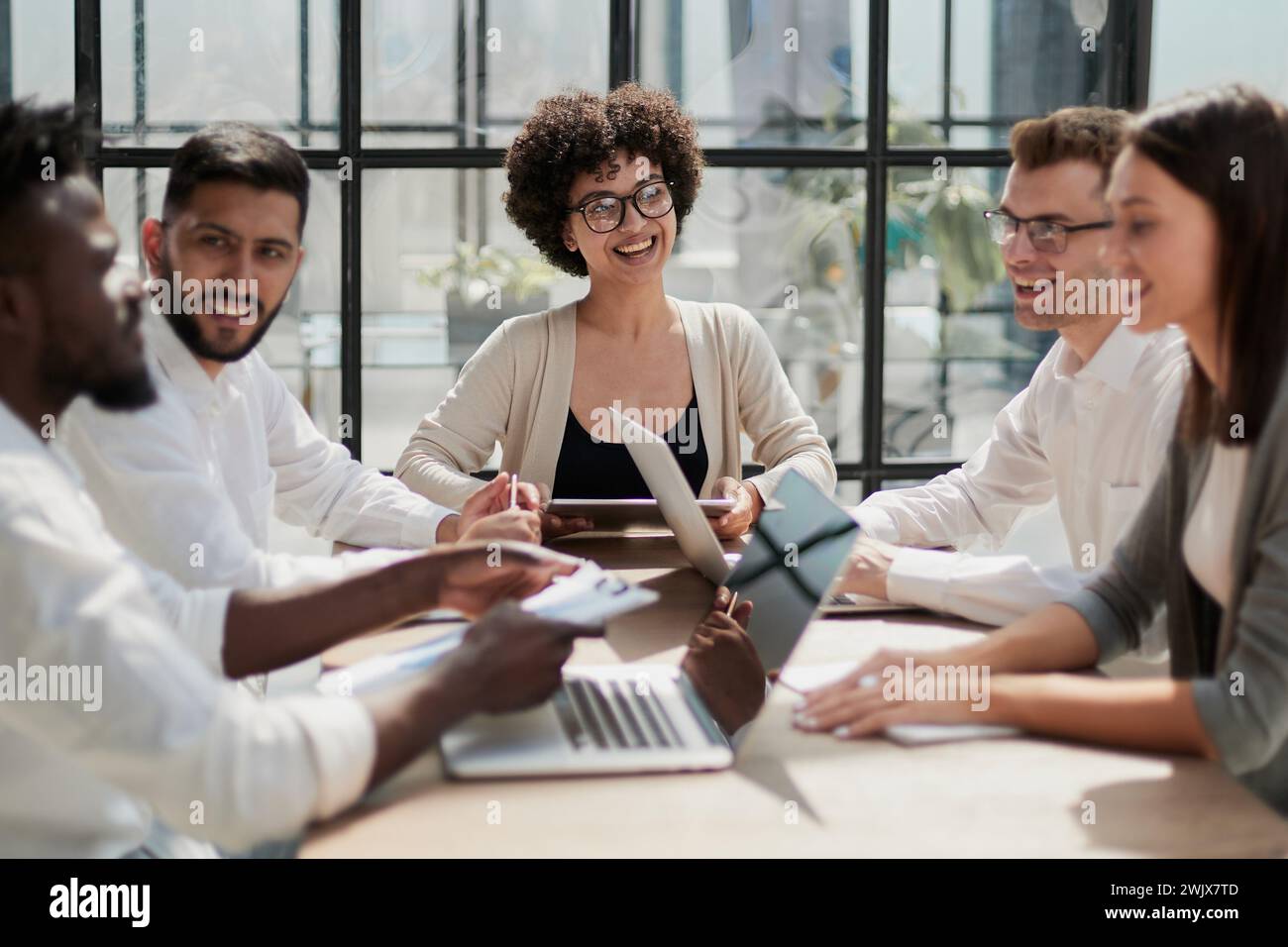 Employees working at computer together, discussing content Stock Photo ...