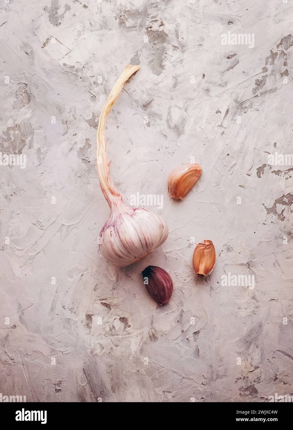 Garlic Cloves and Bulb in Garlic bulbs on light concrete.Top view fresh ...