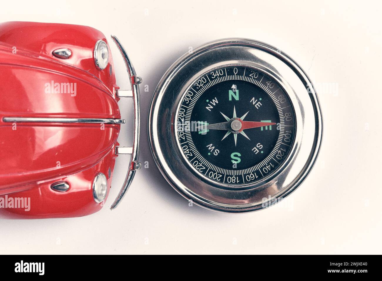Hood red car and compass pointing east. Concept traveling by car Stock ...