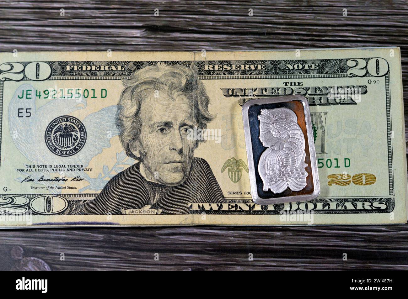 USD American 20 dollars cash money and silver precious metal ounce bar ...