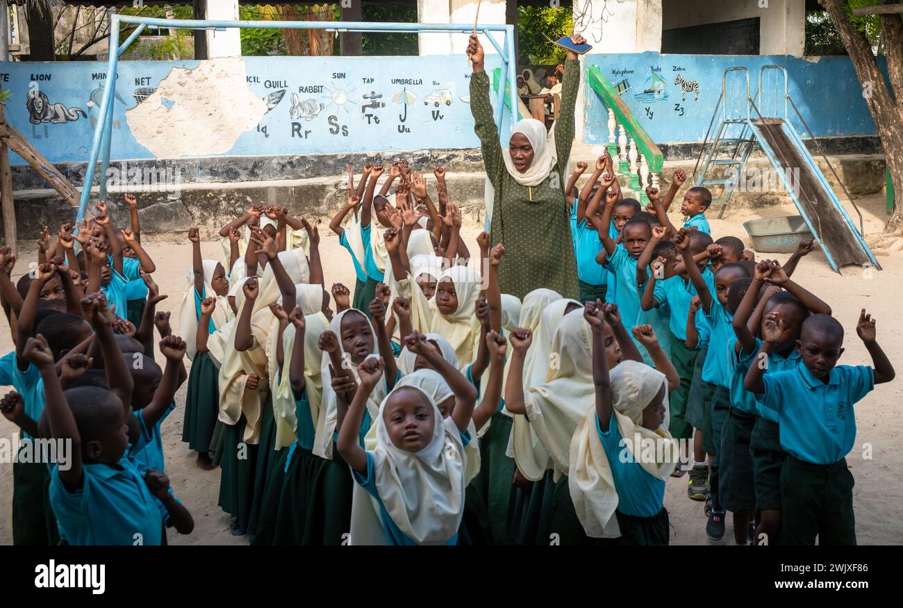 Young muslim boys and girls at morning assembly at Jambiani Primary ...