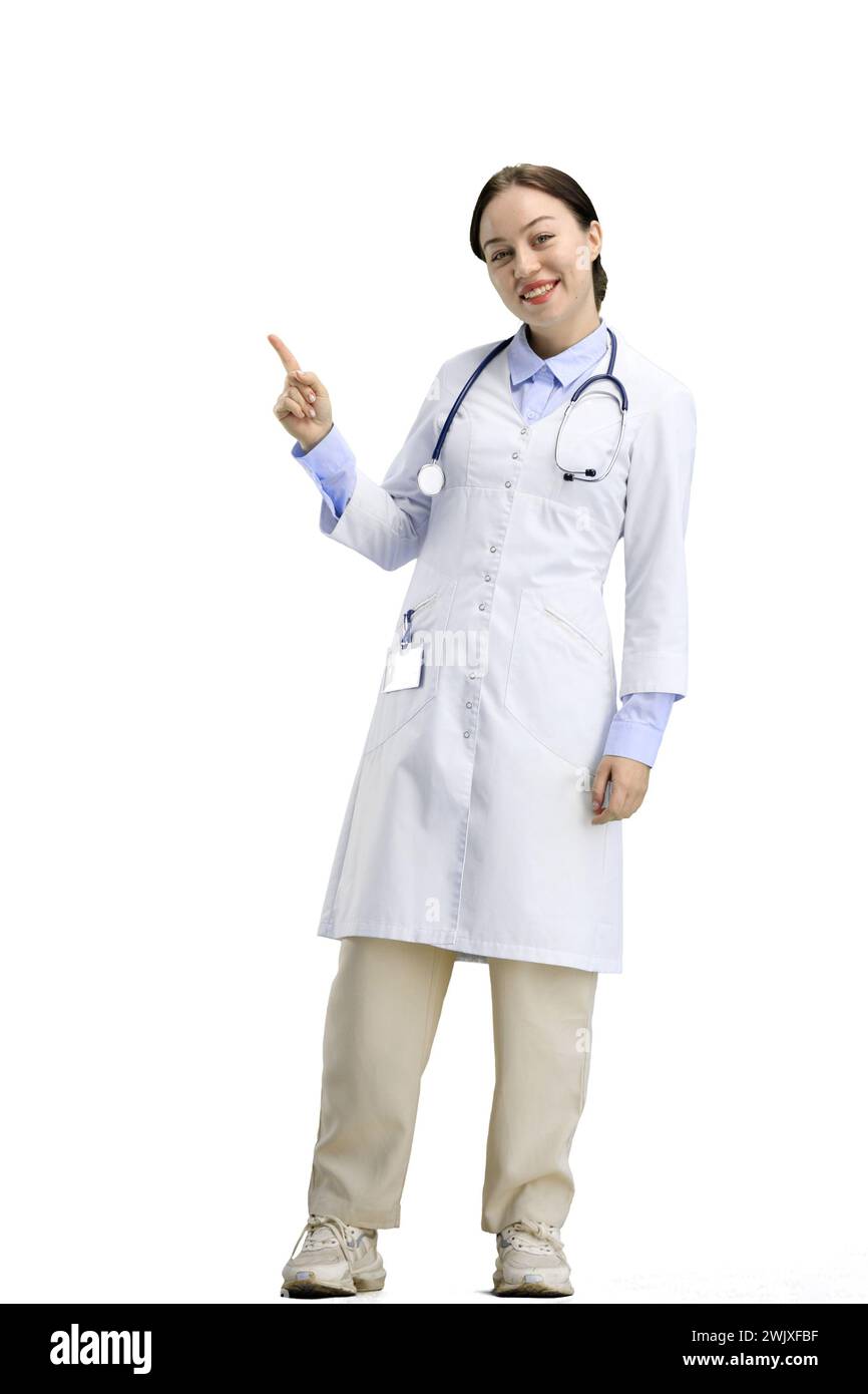 A female doctor, full-length, on a white background, points up Stock ...