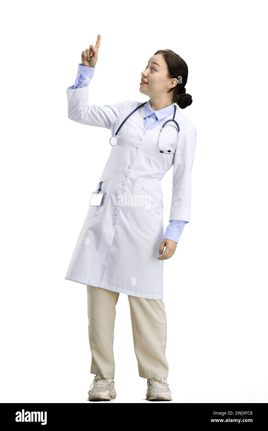 A female doctor, full-length, on a white background, points up Stock ...