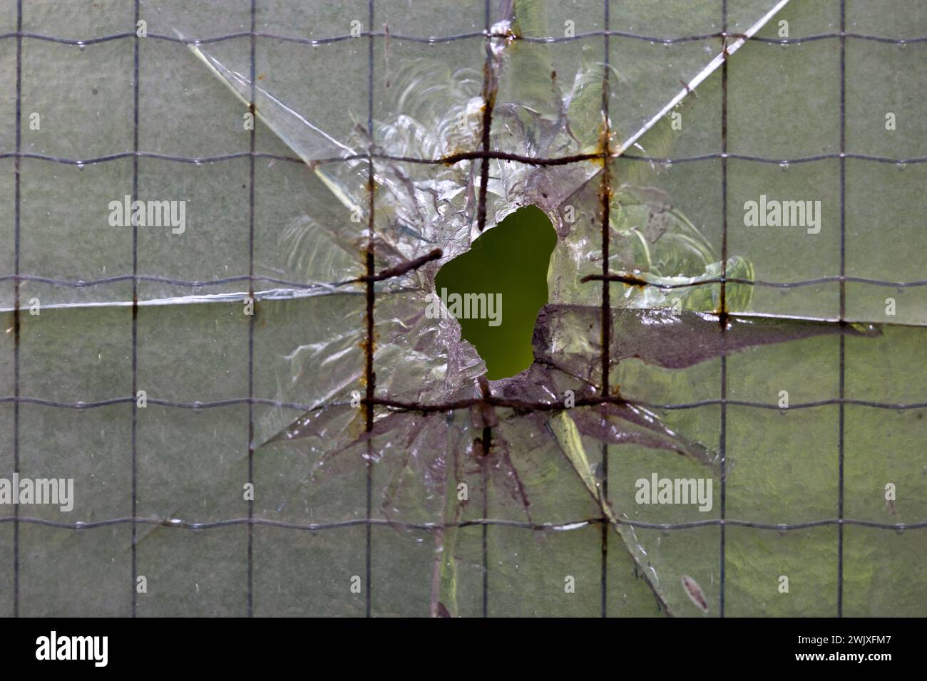 Broken security window Stock Photo - Alamy