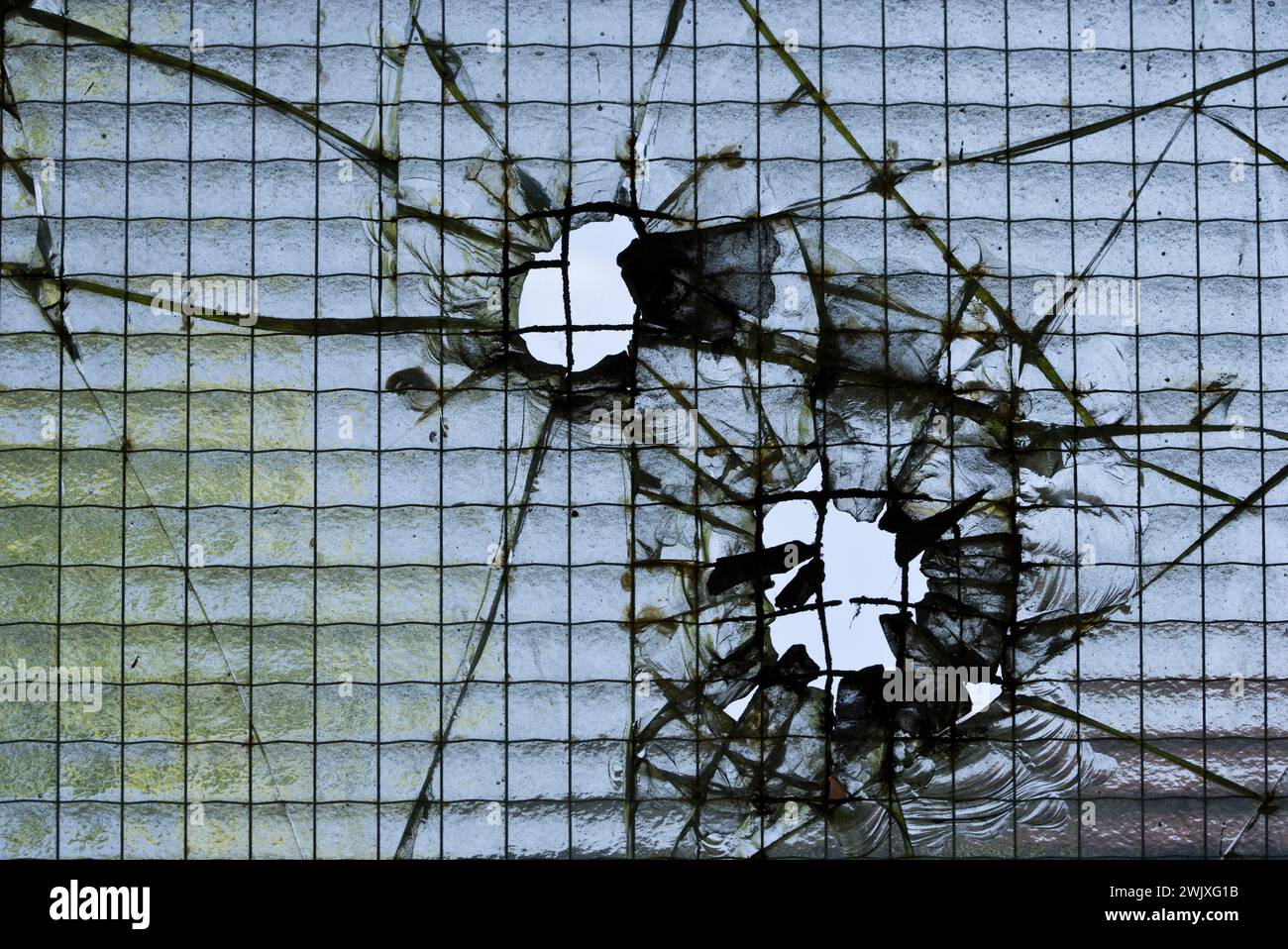 Broken security window Stock Photo - Alamy