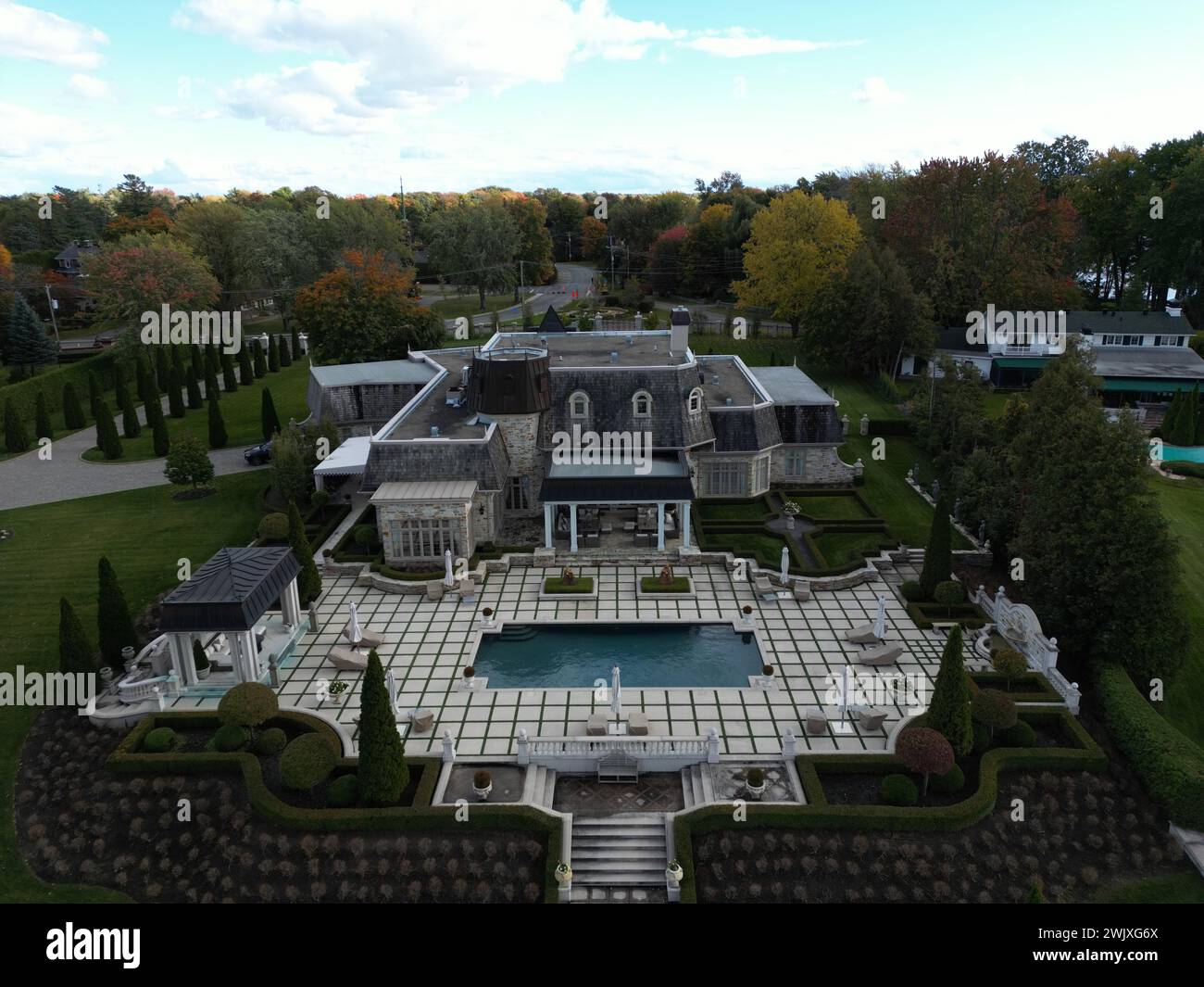 An aerial view of an impressive estate surrounded by lush green foliage ...