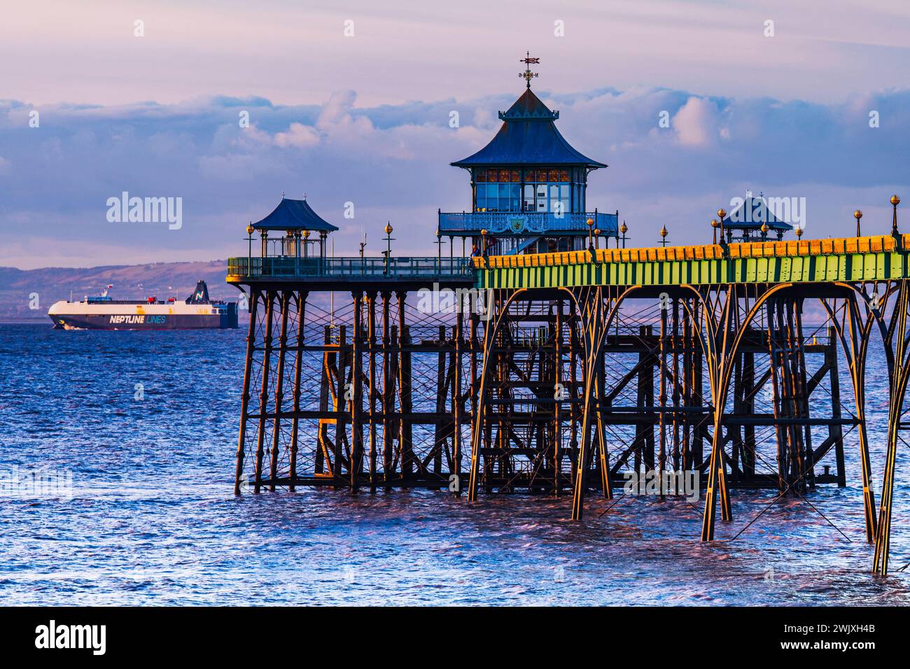 The setting sun lighting up the cloud cover over the Clevedon Pier ...