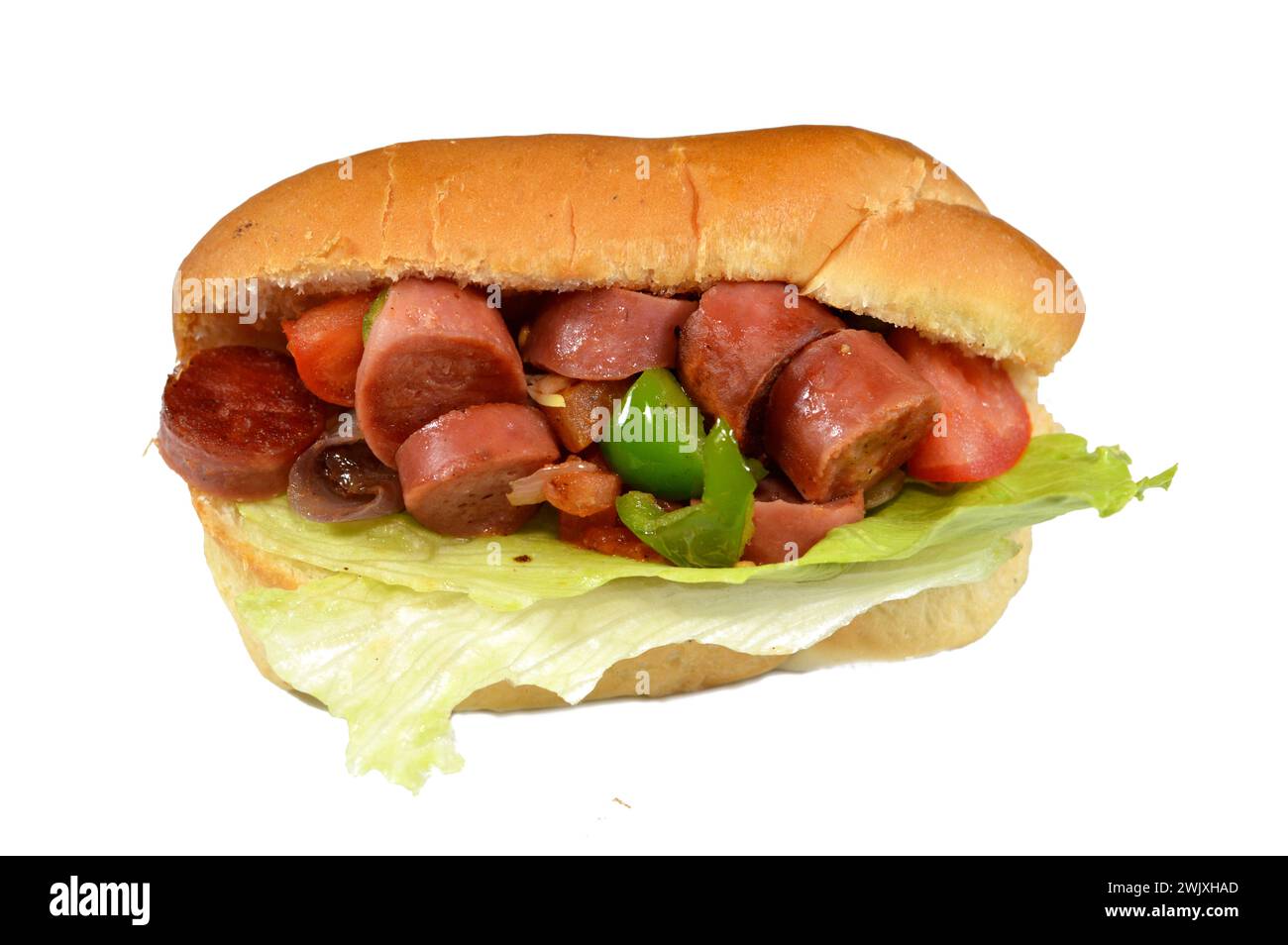 Partially sliced hotdog bun with slices of hot dog grilled beef sausage ...