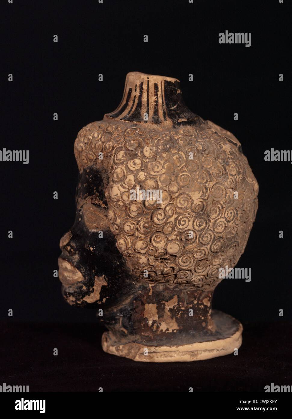 Oenochoe in the shape of a human head. Molded terracotta, black varnish ...