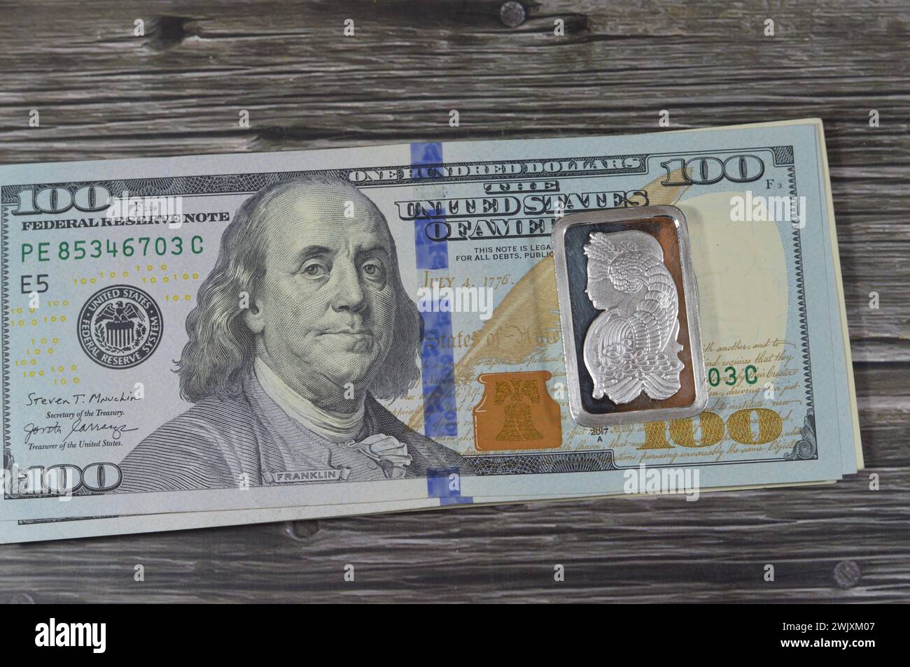USD American 100 dollars cash money and silver precious metal ounce bar ...