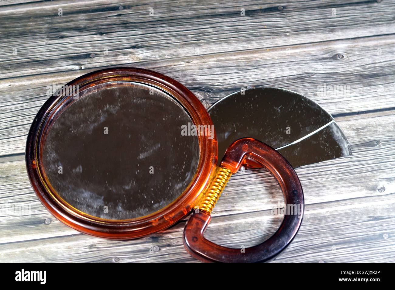 Broken hand mirror, cracked, crushed damaged mirror glass, a mirror is ...