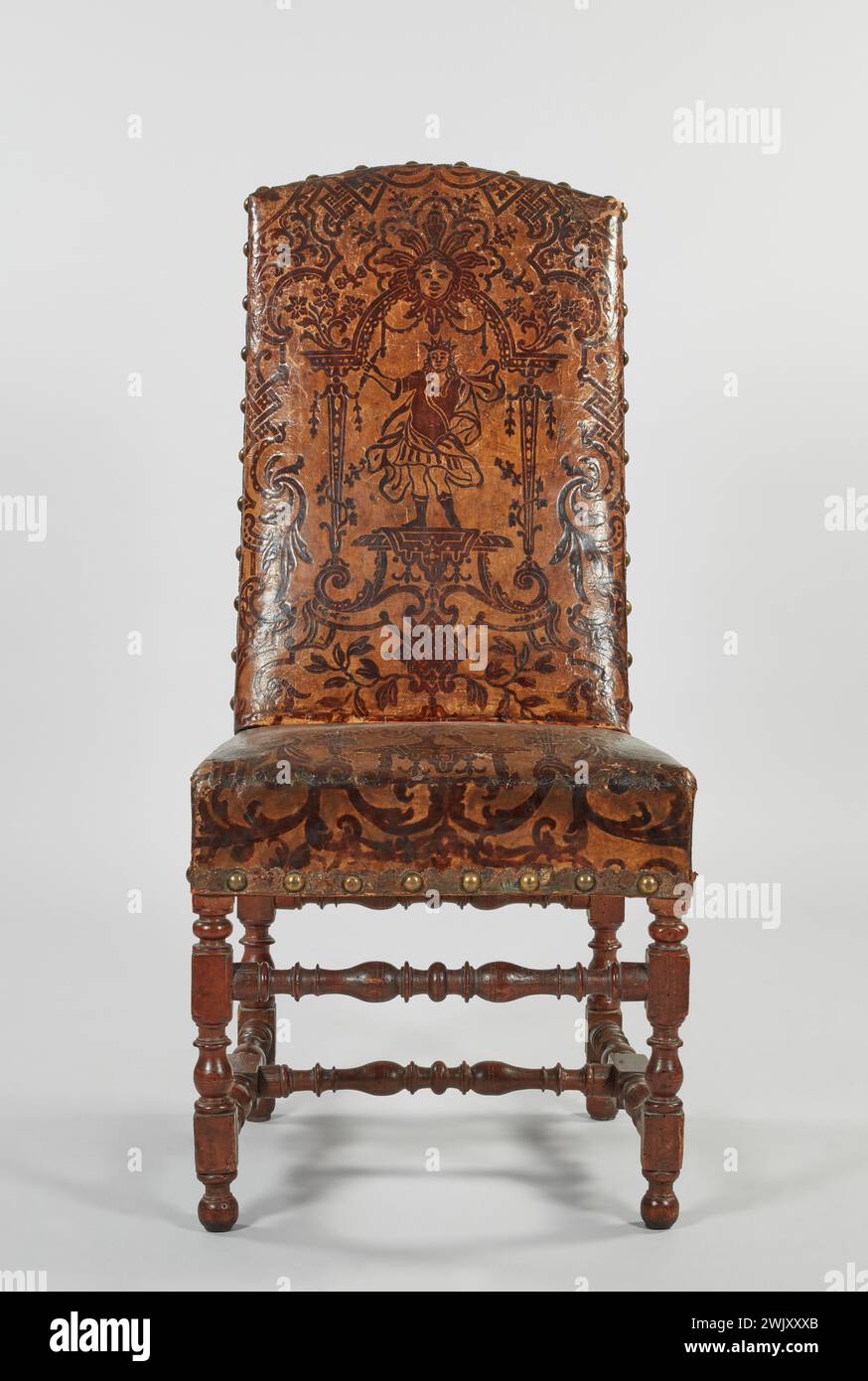 Louis XIII chair in leather with a crowned character pattern. Wood ...