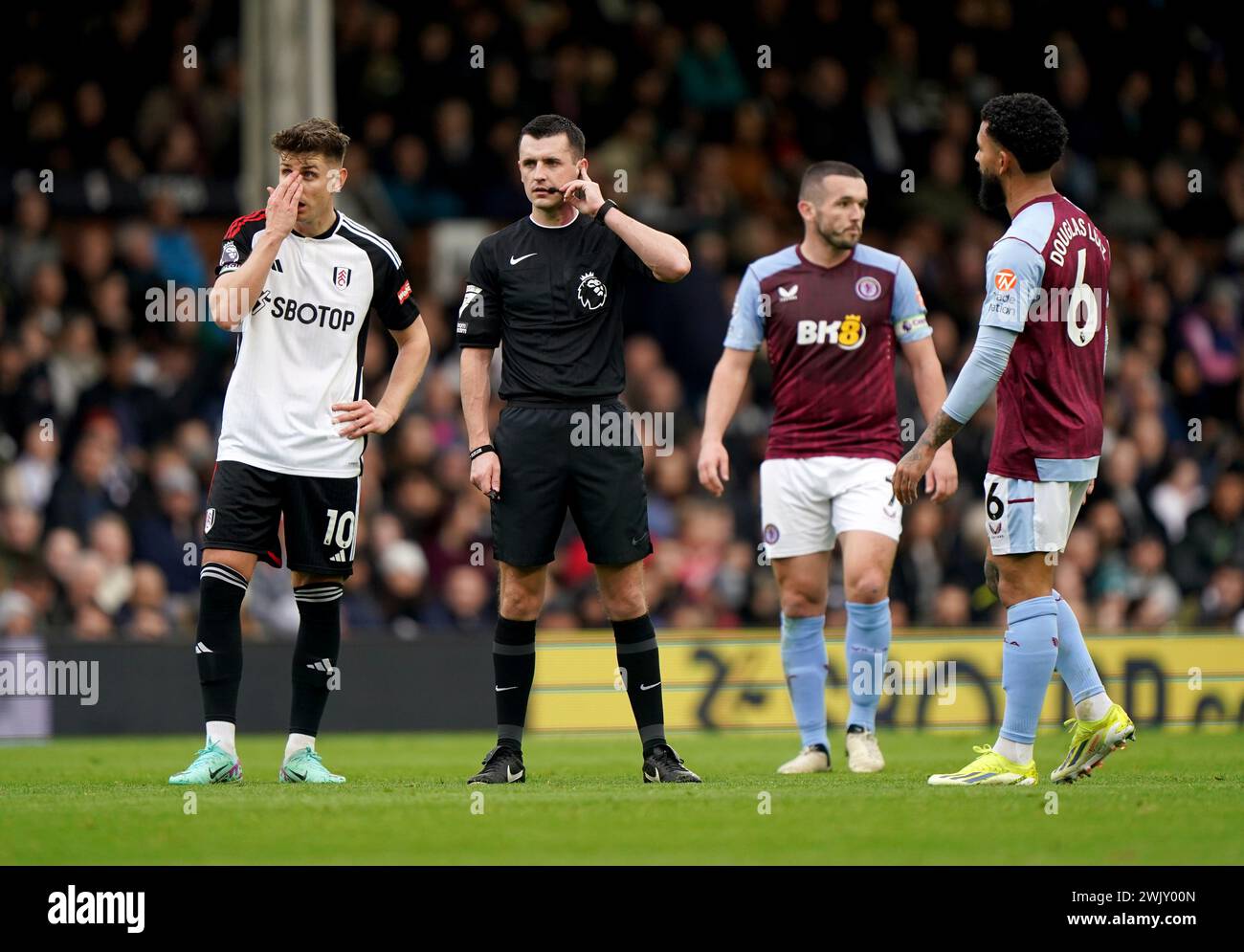 Referee Lewis Smith waits for a VAR check on a goal from Aston Villa's ...