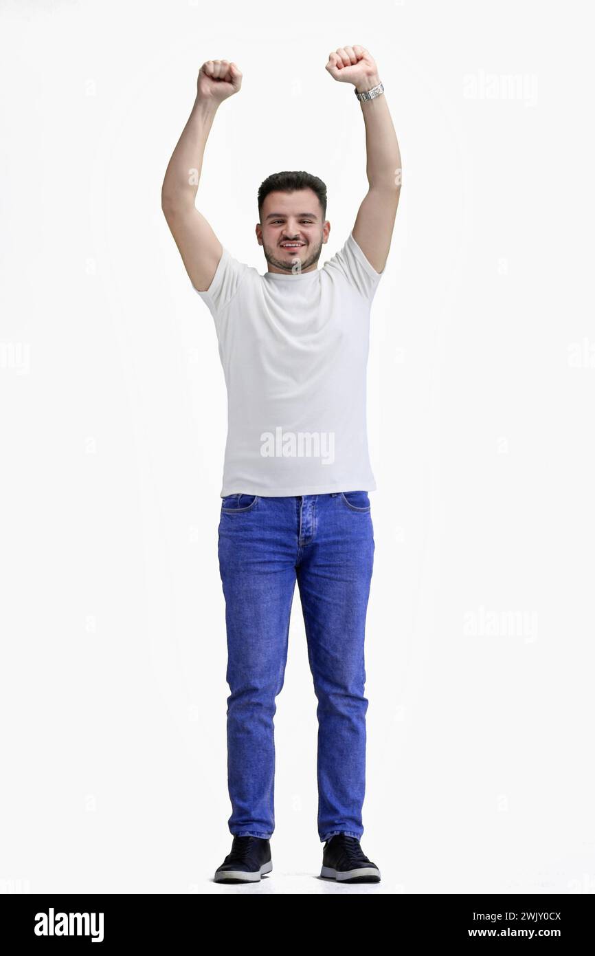 A man, full-length, on a white background, raised his hands up Stock ...