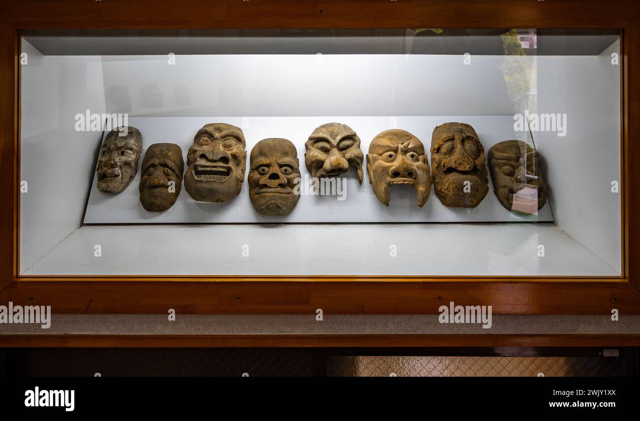 Traditional wooden face masks in display. Hakozaki Hachiman Shrine ...