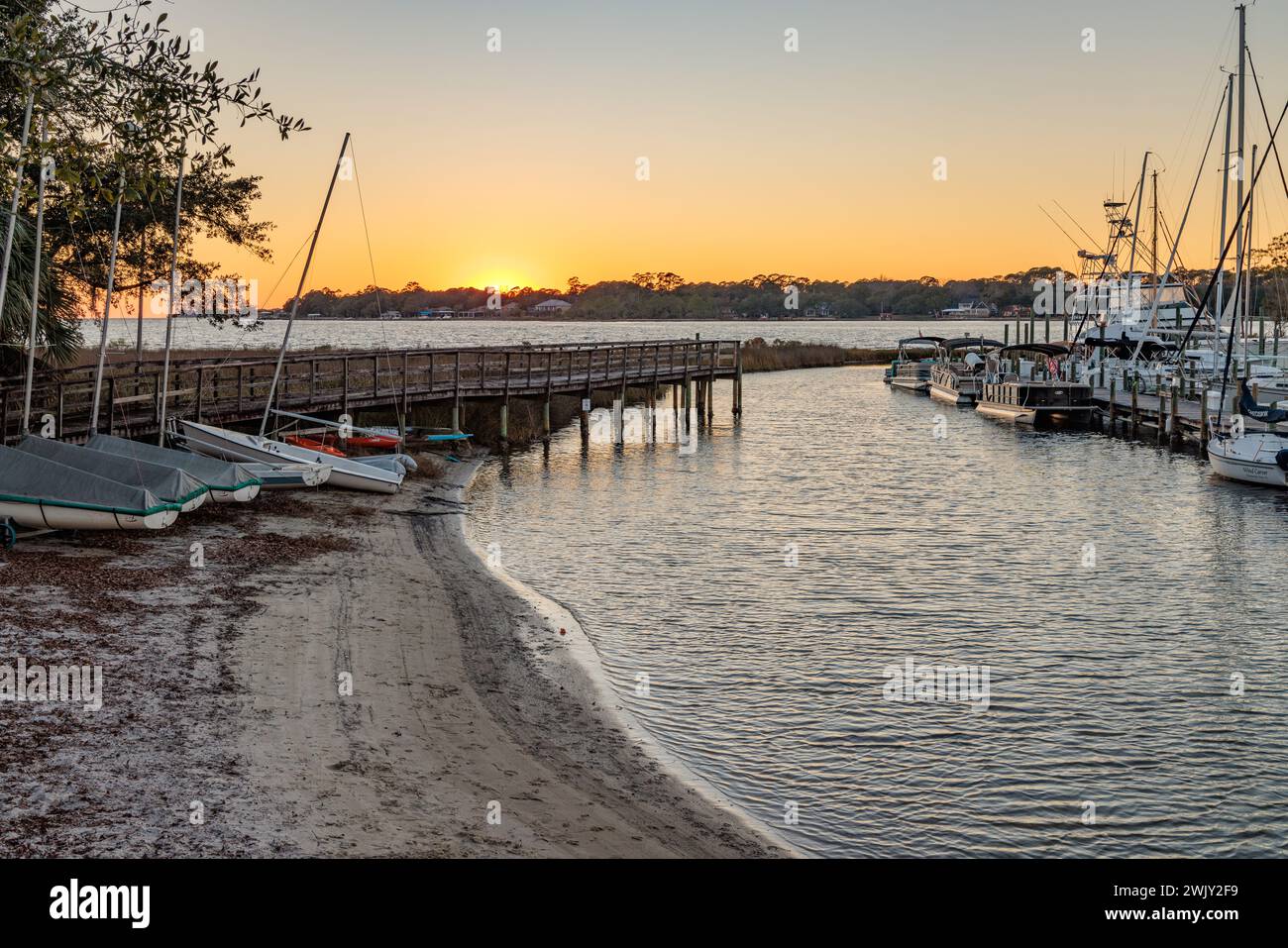 Sun setting behind marina on Ward Cove off of Rocky Bayou in Niceville ...