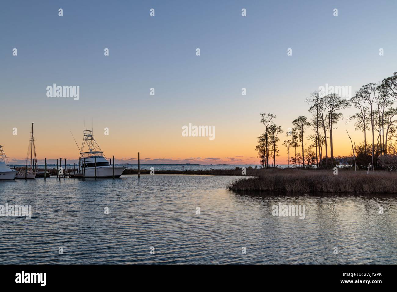 Sun setting behind fishing boat in marina on Ward Cove off of Rocky ...