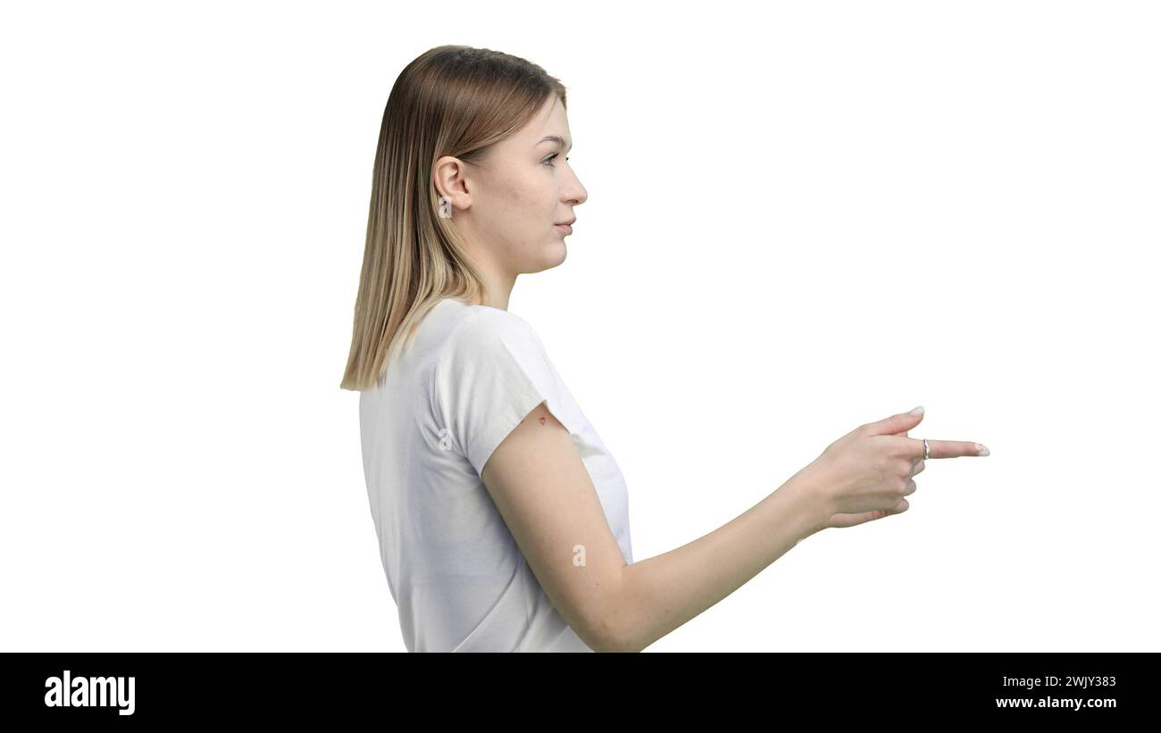 A woman, close-up, on a white background, points to the side Stock ...