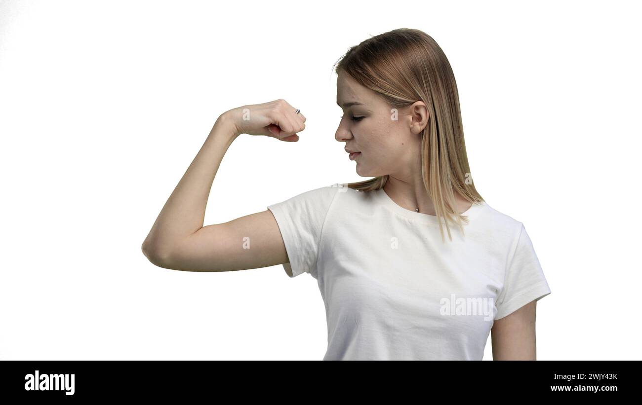 A woman, close-up, on a white background, shows strength Stock Photo ...