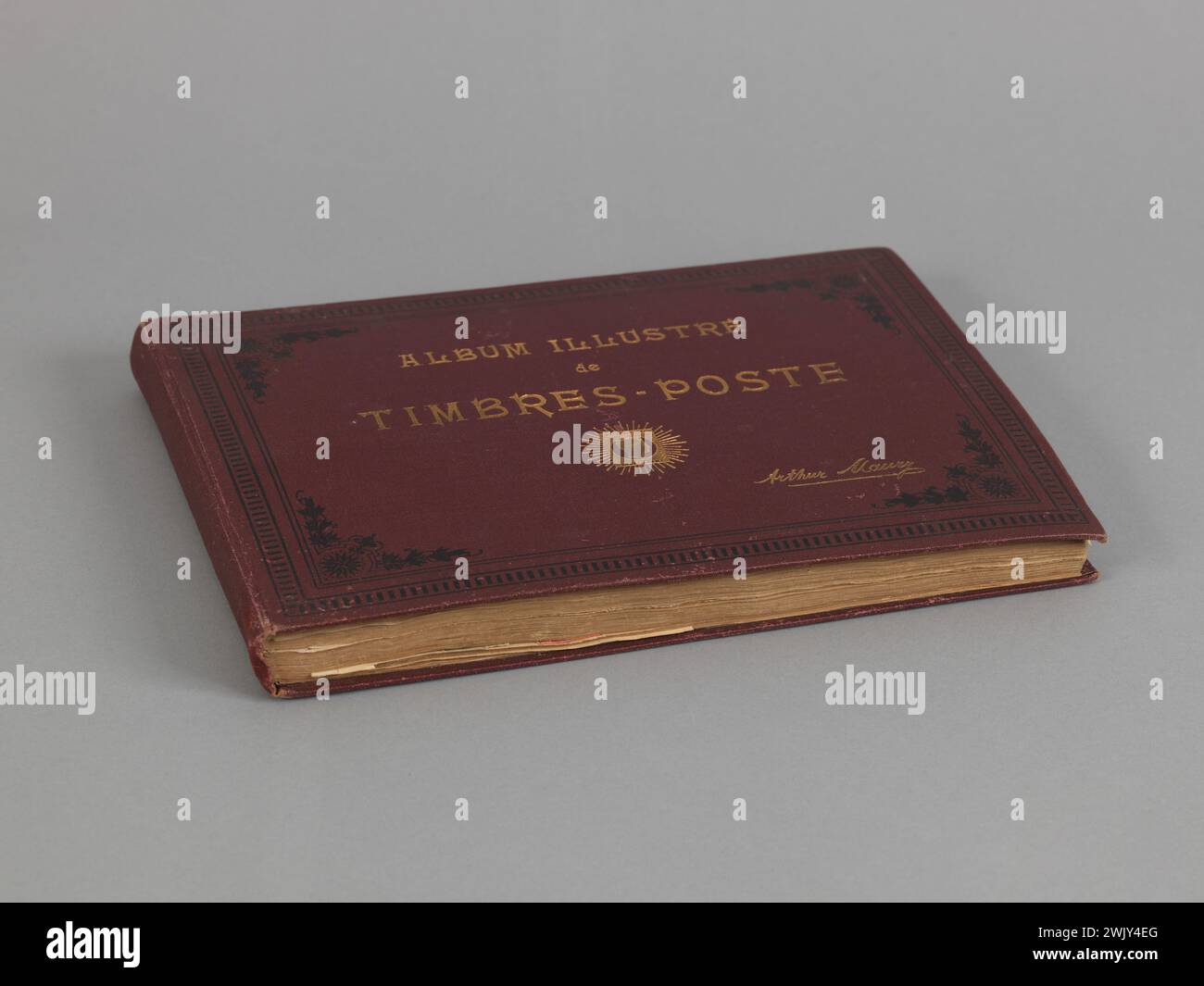 Illustrated album of postage stamps (wrapped in a newspaper) that ...