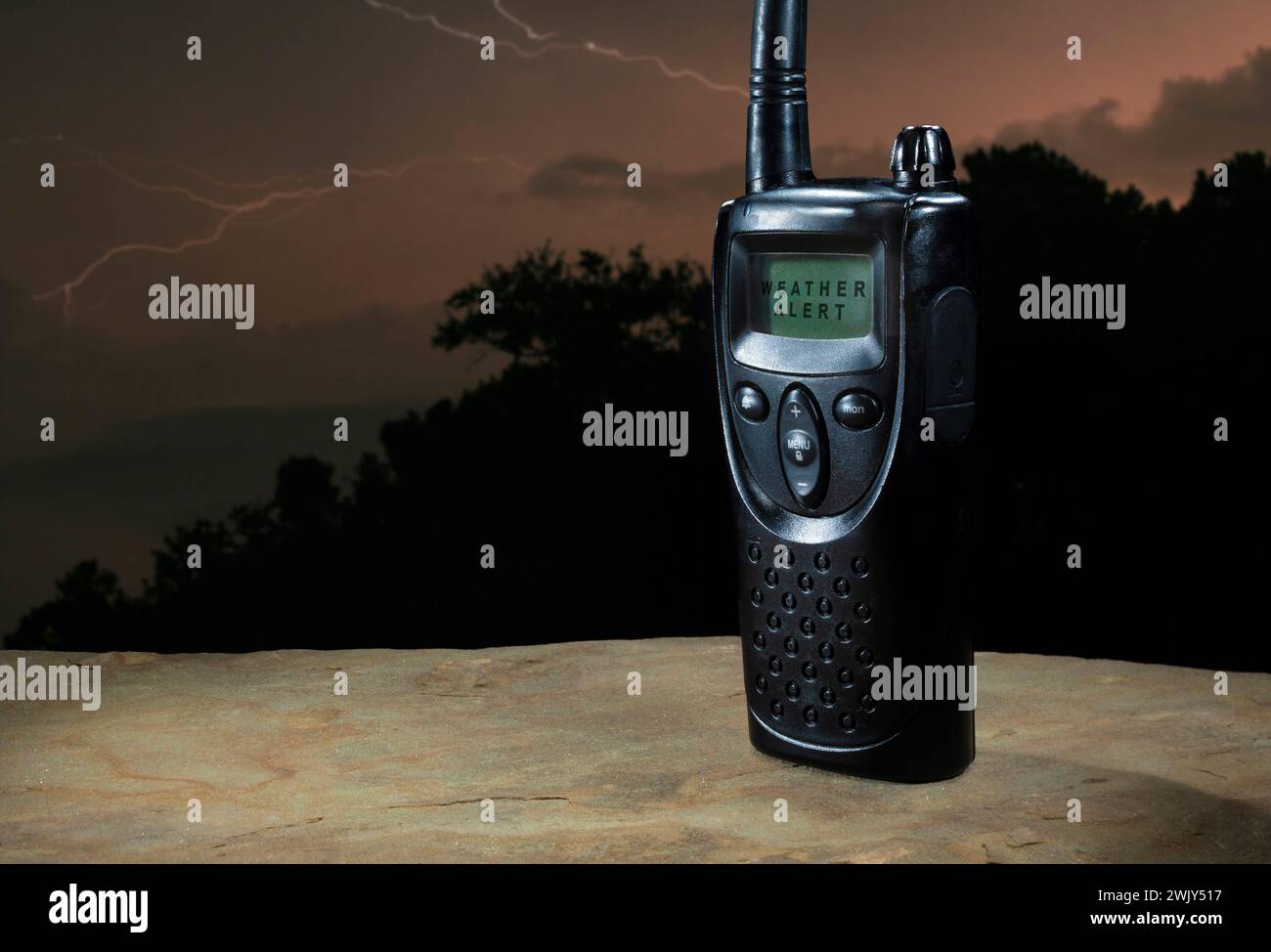 Handheld two way radio with a display showing a weather alert has been ...