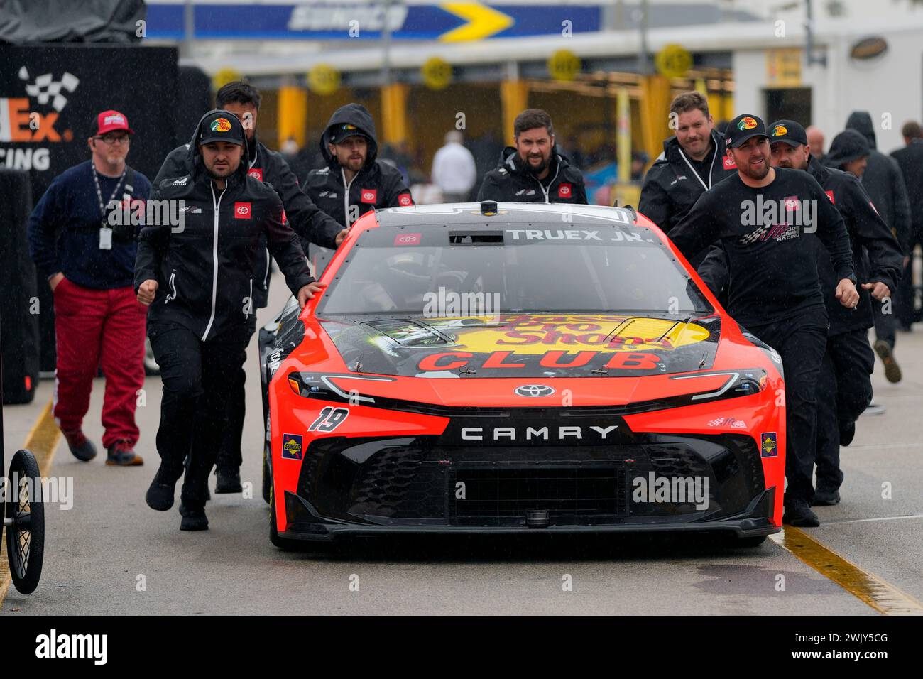 Martin Truex Jr.'s crew pushes his car to his garage after practice ...