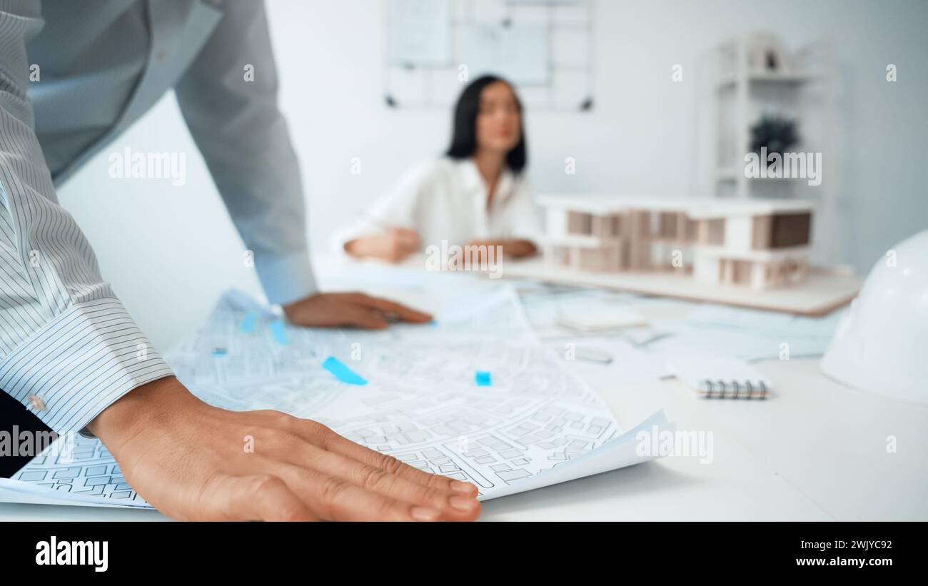 Skilled caucasian interior designer working with house model while ...