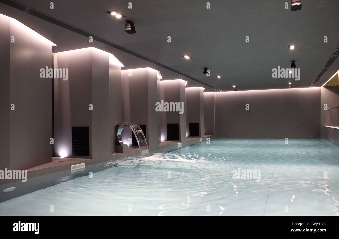 Swimming pool and artificial waterfall at the spa center of modern ...