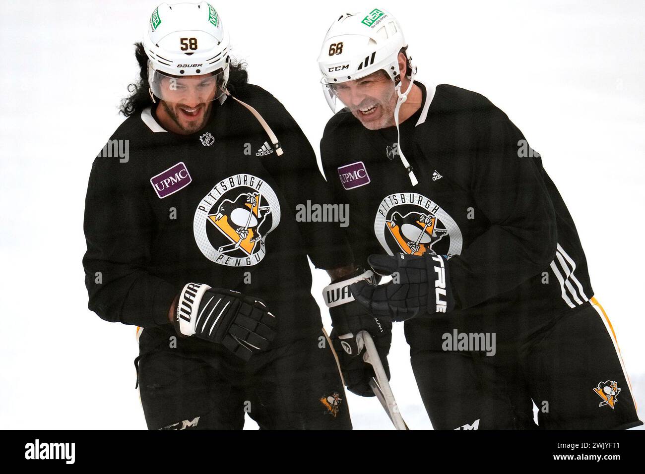 Pittsburgh Penguins' Kris Letang, left, shares a laugh with former ...