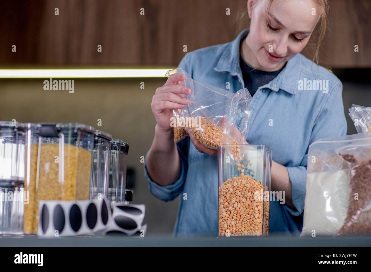 A woman uses containers to organize food in the kitchen. Layout and ...