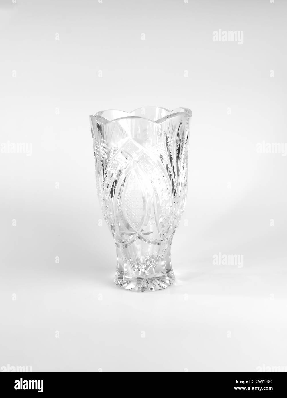 Empty crystal vase on white background. The vase was made in the mid ...