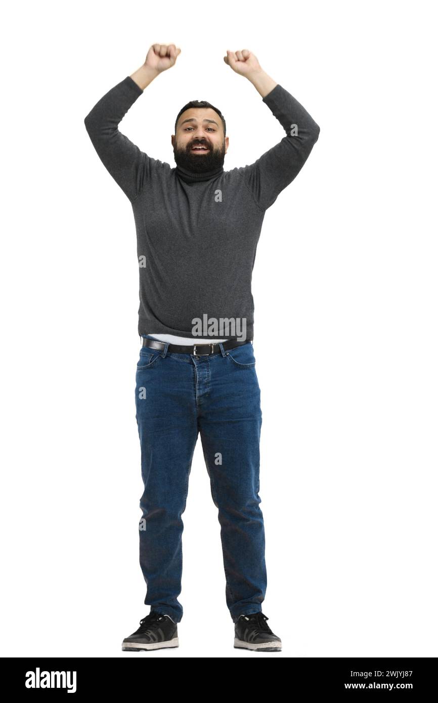 A man, full-length, on a white background, raised his hands up Stock ...