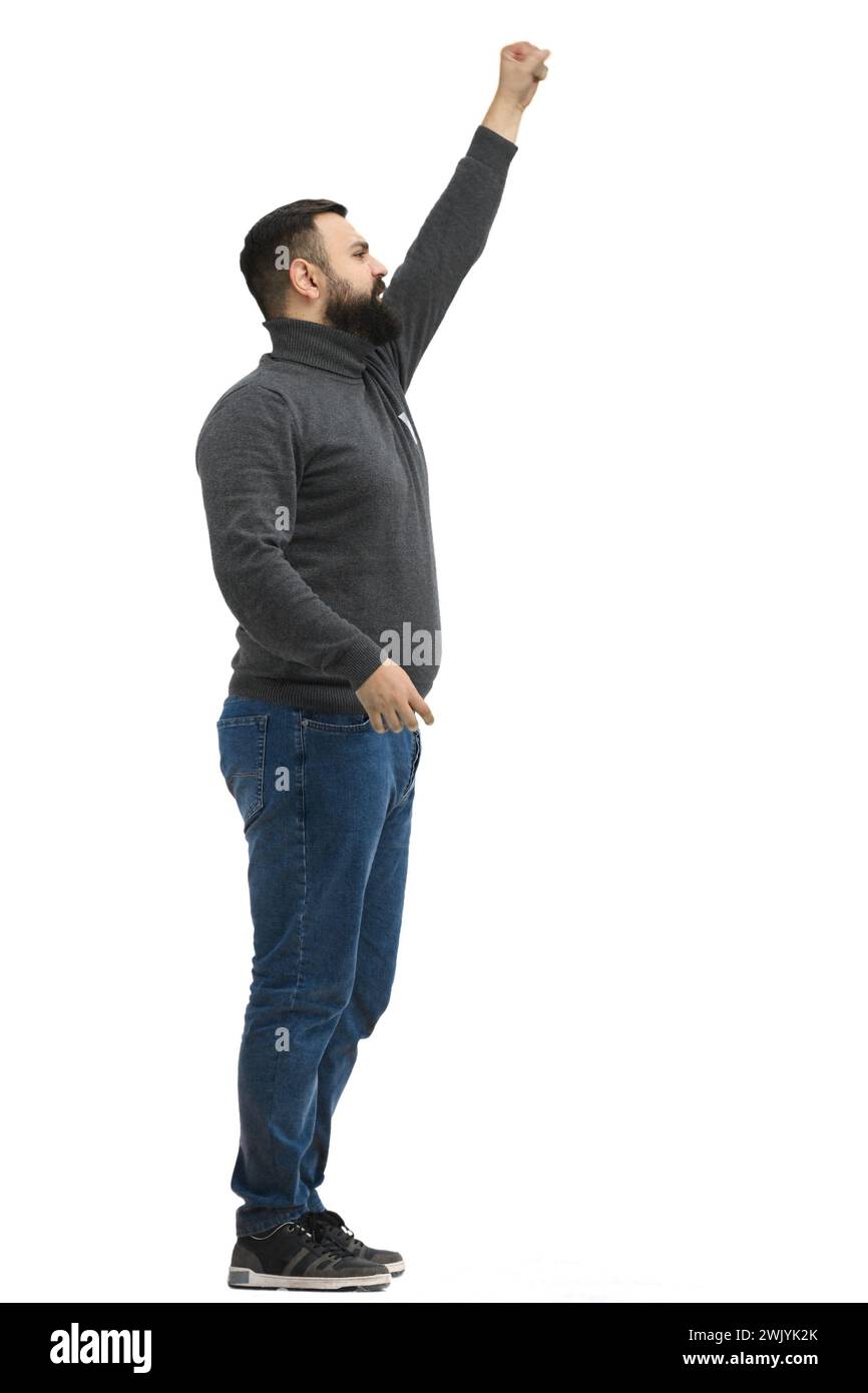 A man, full-length, on a white background, raised his hand up Stock ...