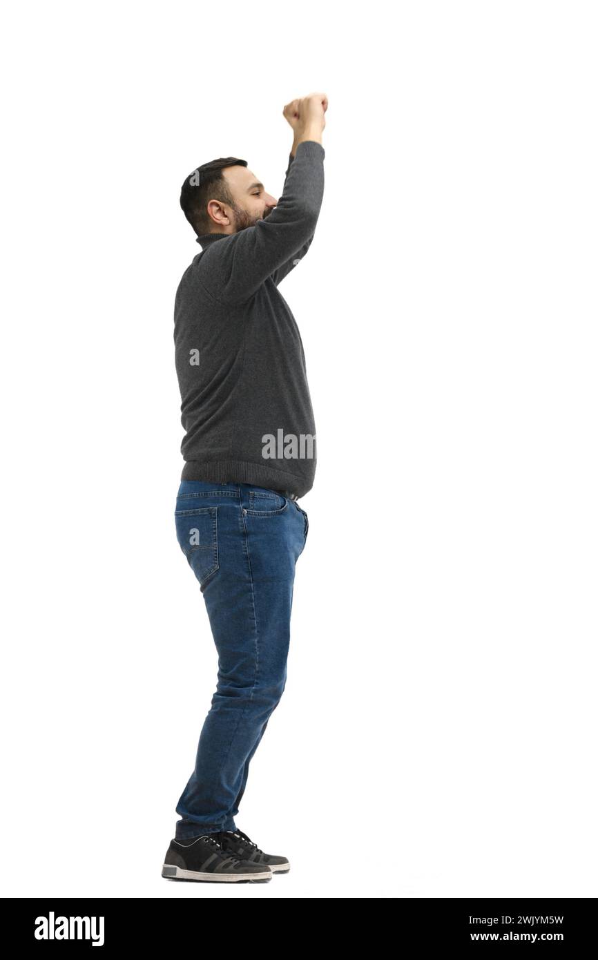 A man, full-length, on a white background, raised his hands up Stock ...