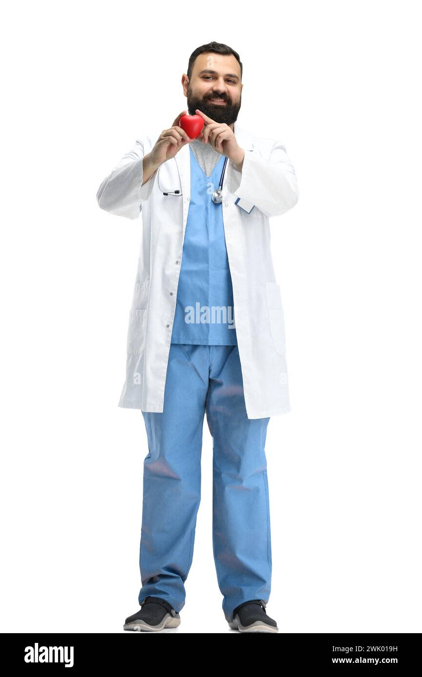 Male doctor, full-length, on a white background, shows a heart Stock ...