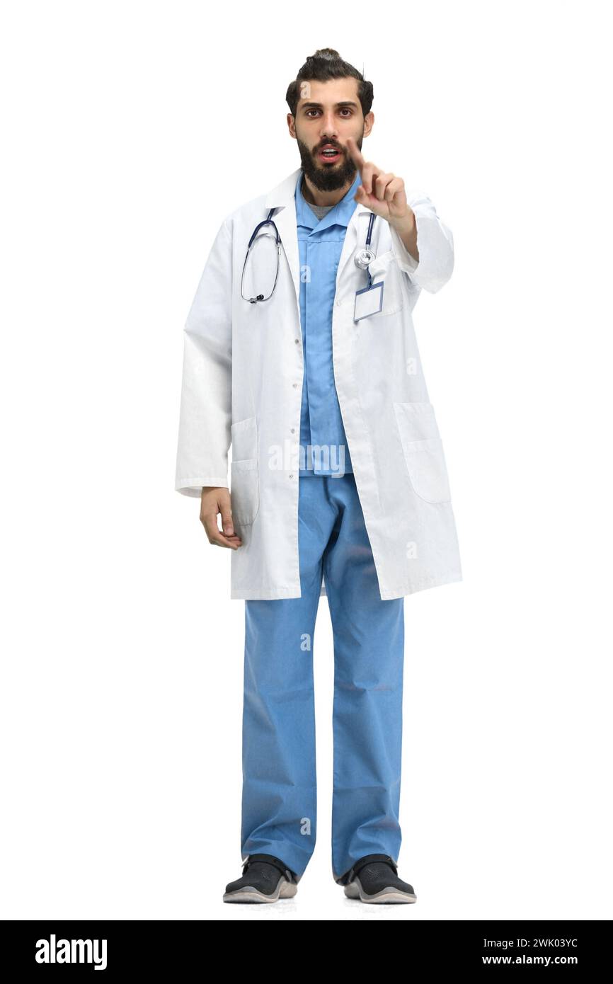 A male doctor, full-length, on a white background, shows a forbidding ...